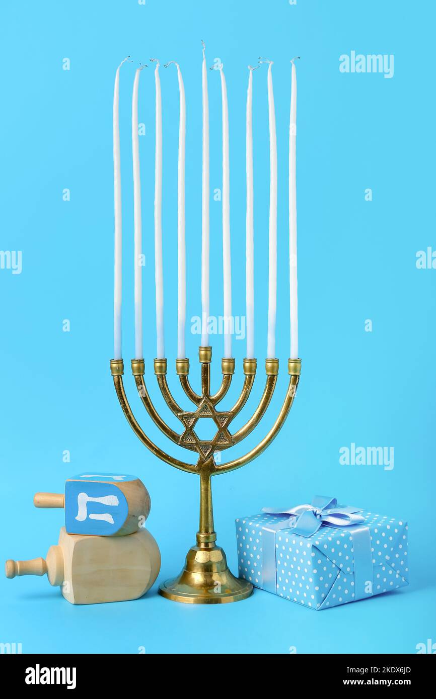 Menorah with candles, gift and dreidels for Hanukkah celebration on ...