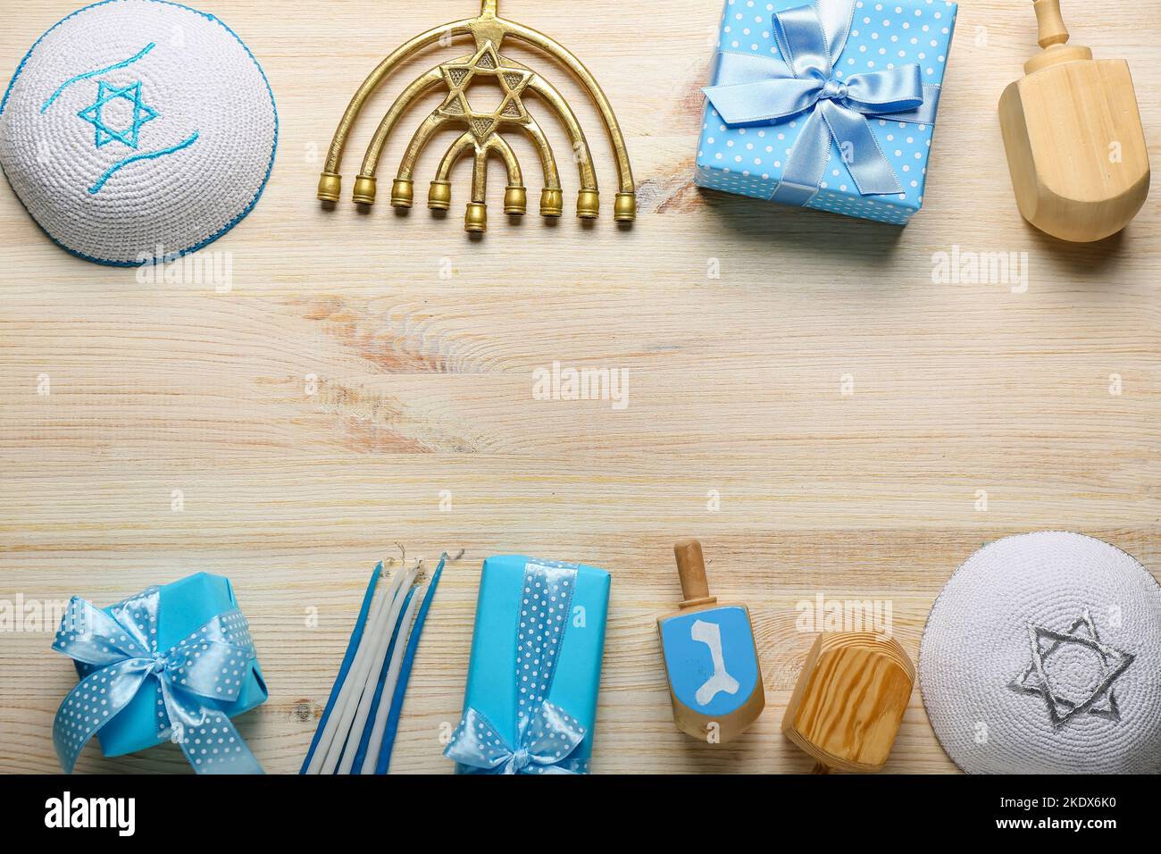 Frame made of gifts, menorah, candles, Jewish hats and dreidels for ...