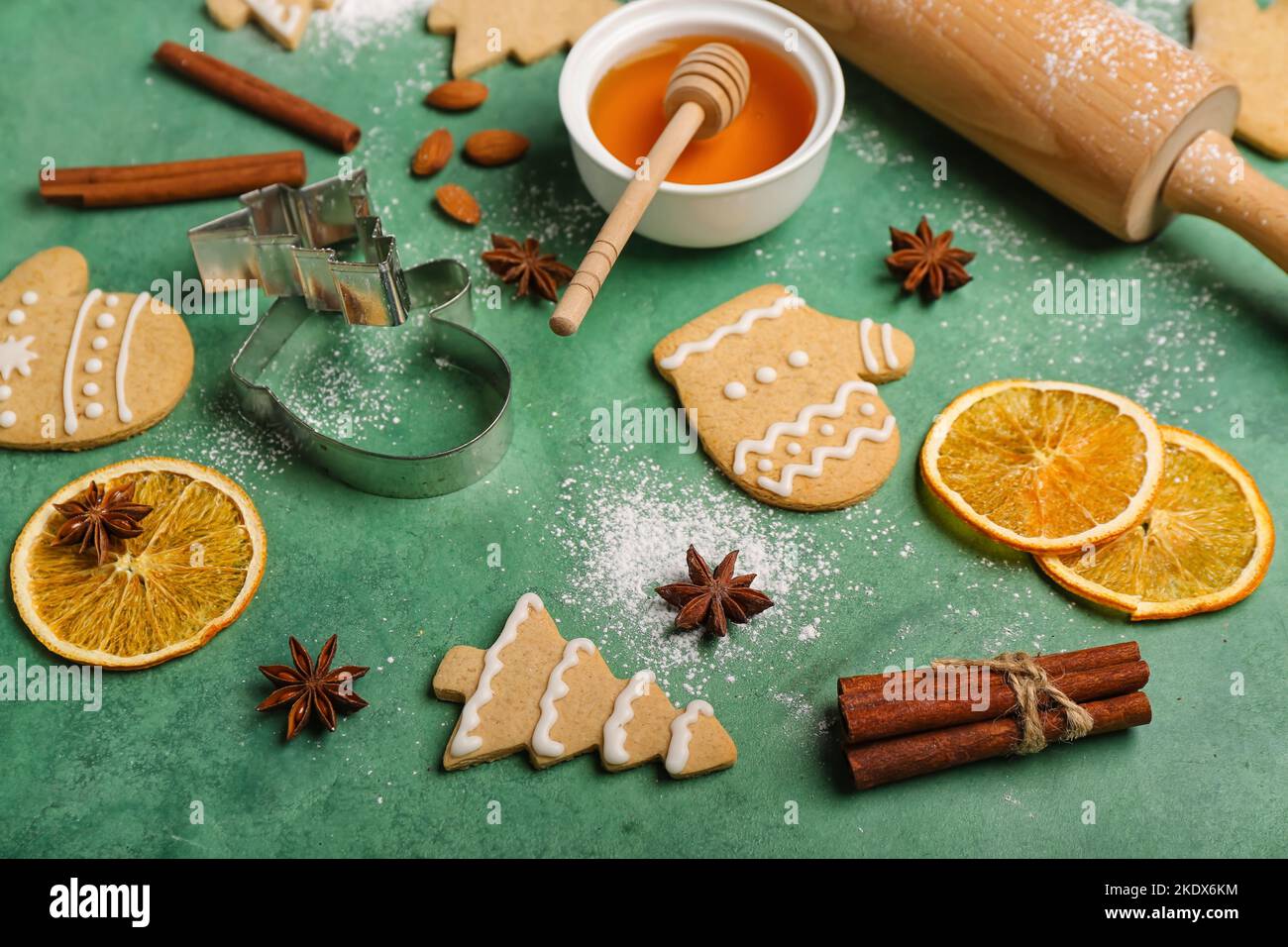 Tasty Christmas cookies, cutters and ingredients on color background ...