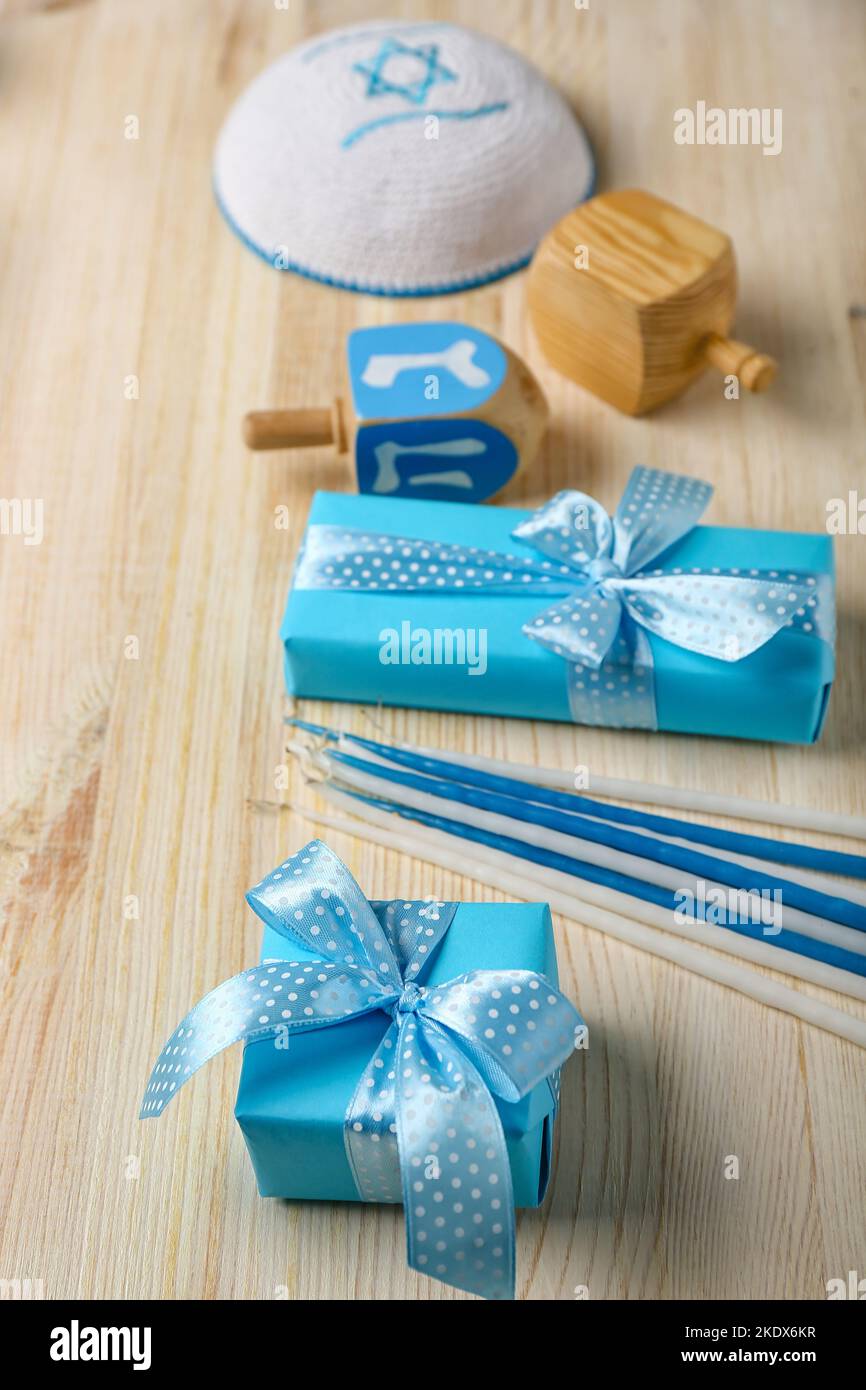 Gifts with candles and dreidels for Hannukah celebration on wooden ...