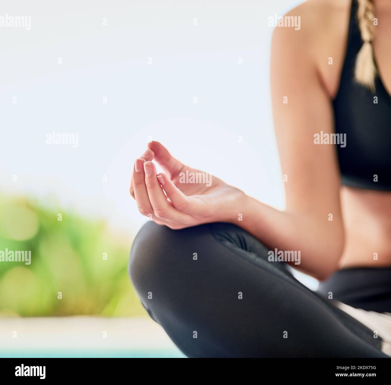 Finding balance. an unrecognizable young woman meditating outside Stock ...