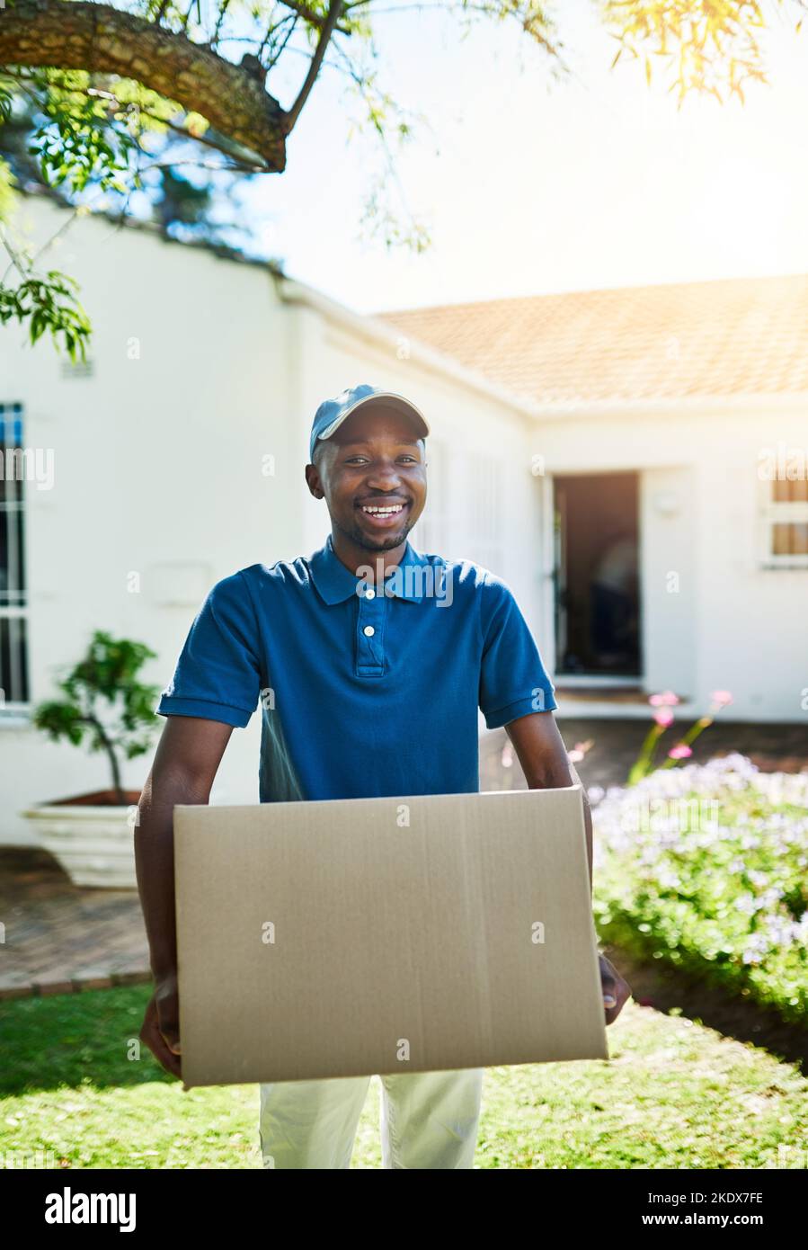 We collect AND deliver. Portrait of a young delivery man carrying a ...