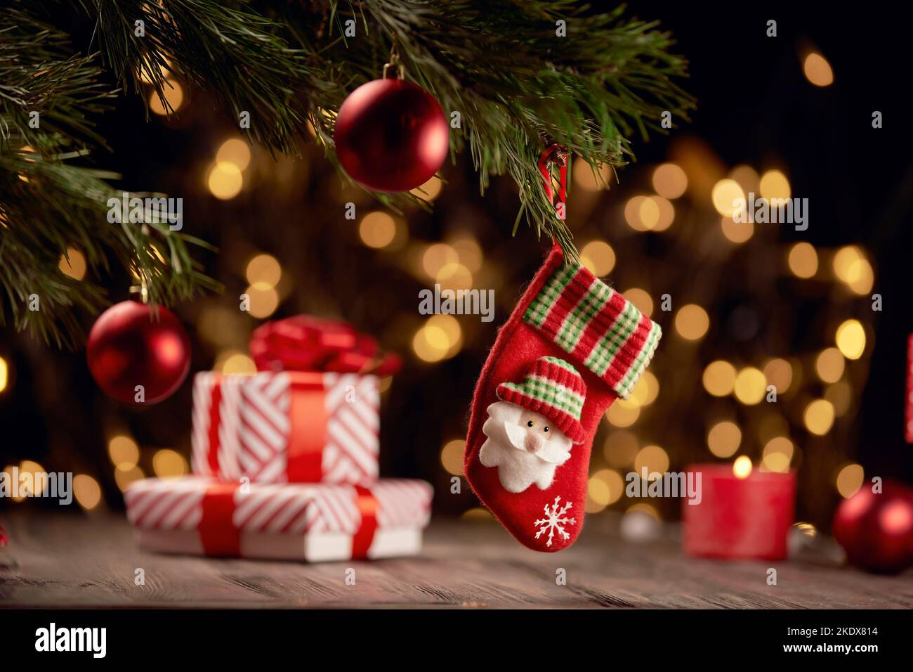 red Christmas stocking on a blurry festive background Stock Photo - Alamy