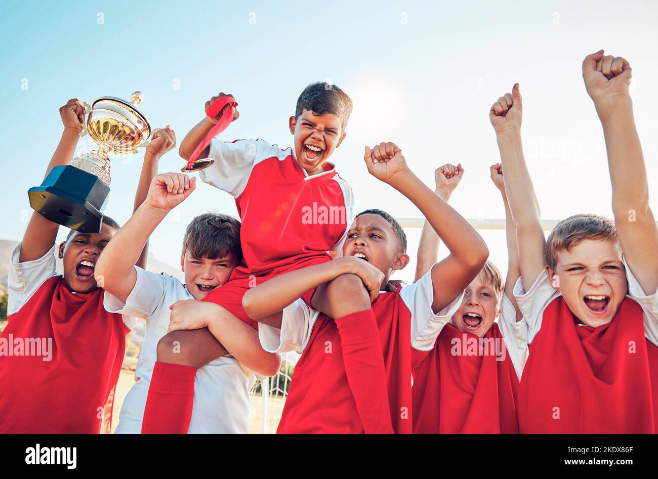Soccer, winner team and sport trophy celebration in sunshine together ...