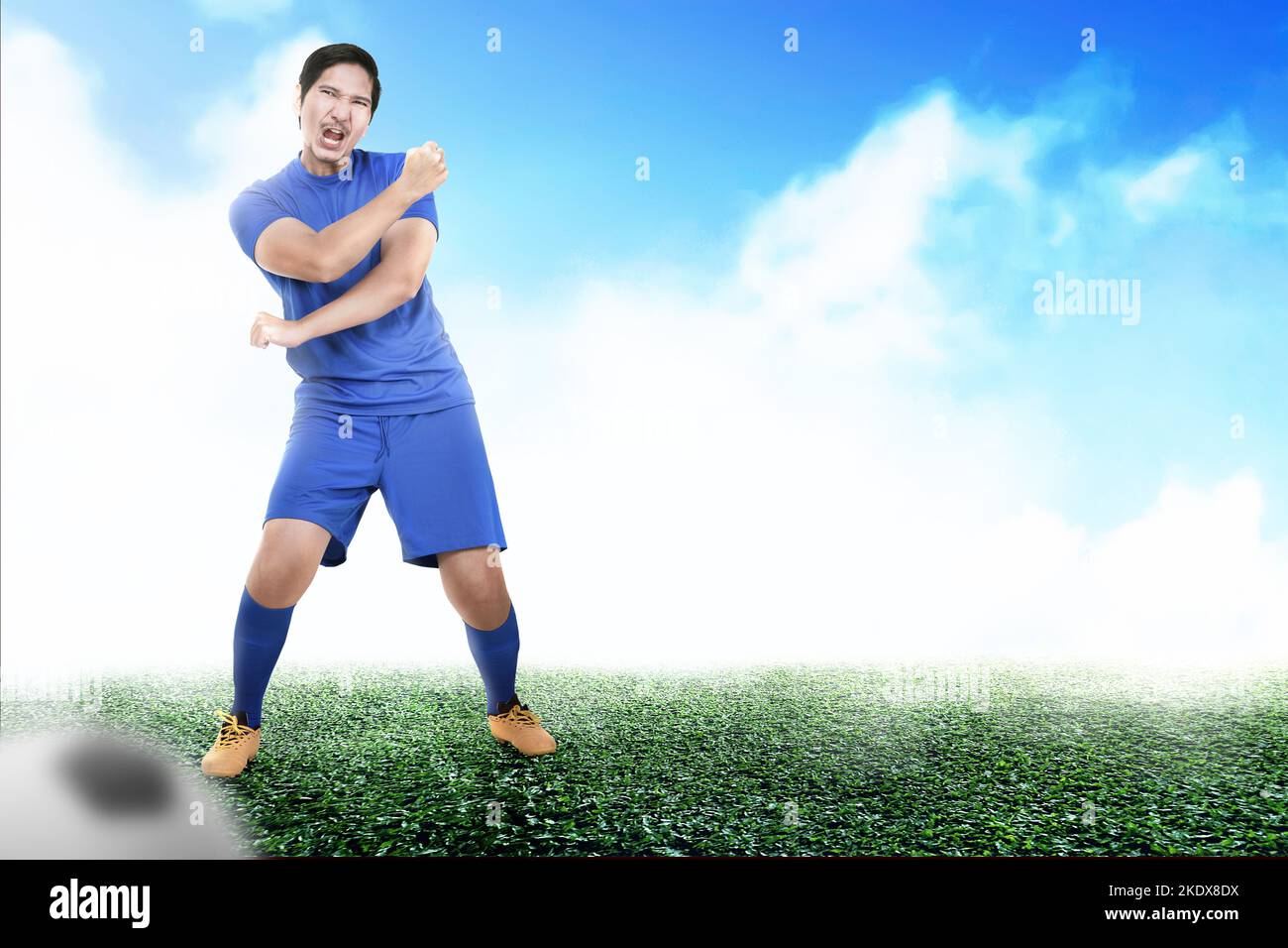 Asian football player man in a blue jersey celebrates the victory on ...