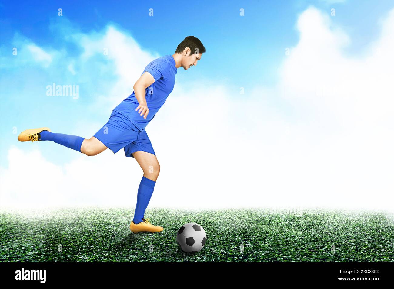 Asian football player man in a blue jersey kicking the ball on the ...