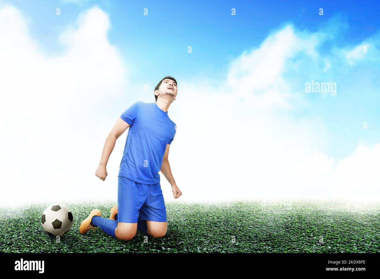 Asian football player man in a blue jersey celebrates the victory on ...