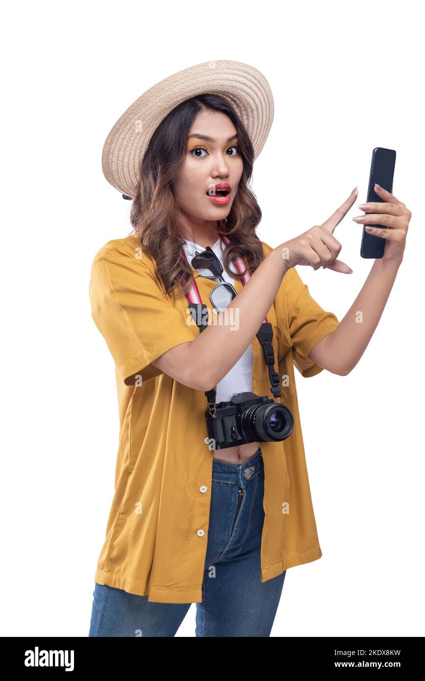 Asian woman with a hat and camera using a mobile phone isolated over ...