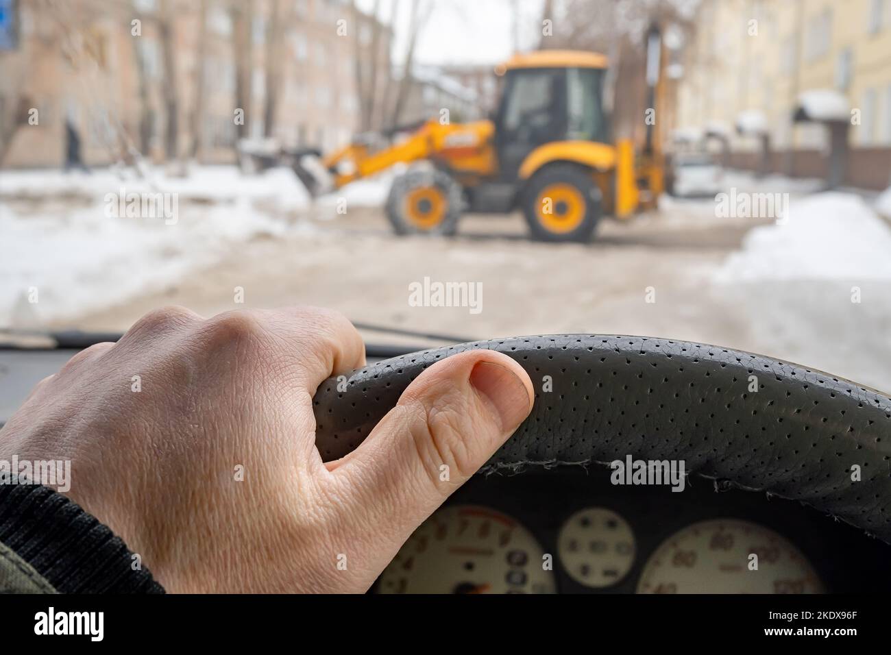 car driver hand on the steering wheel against the background of a ...