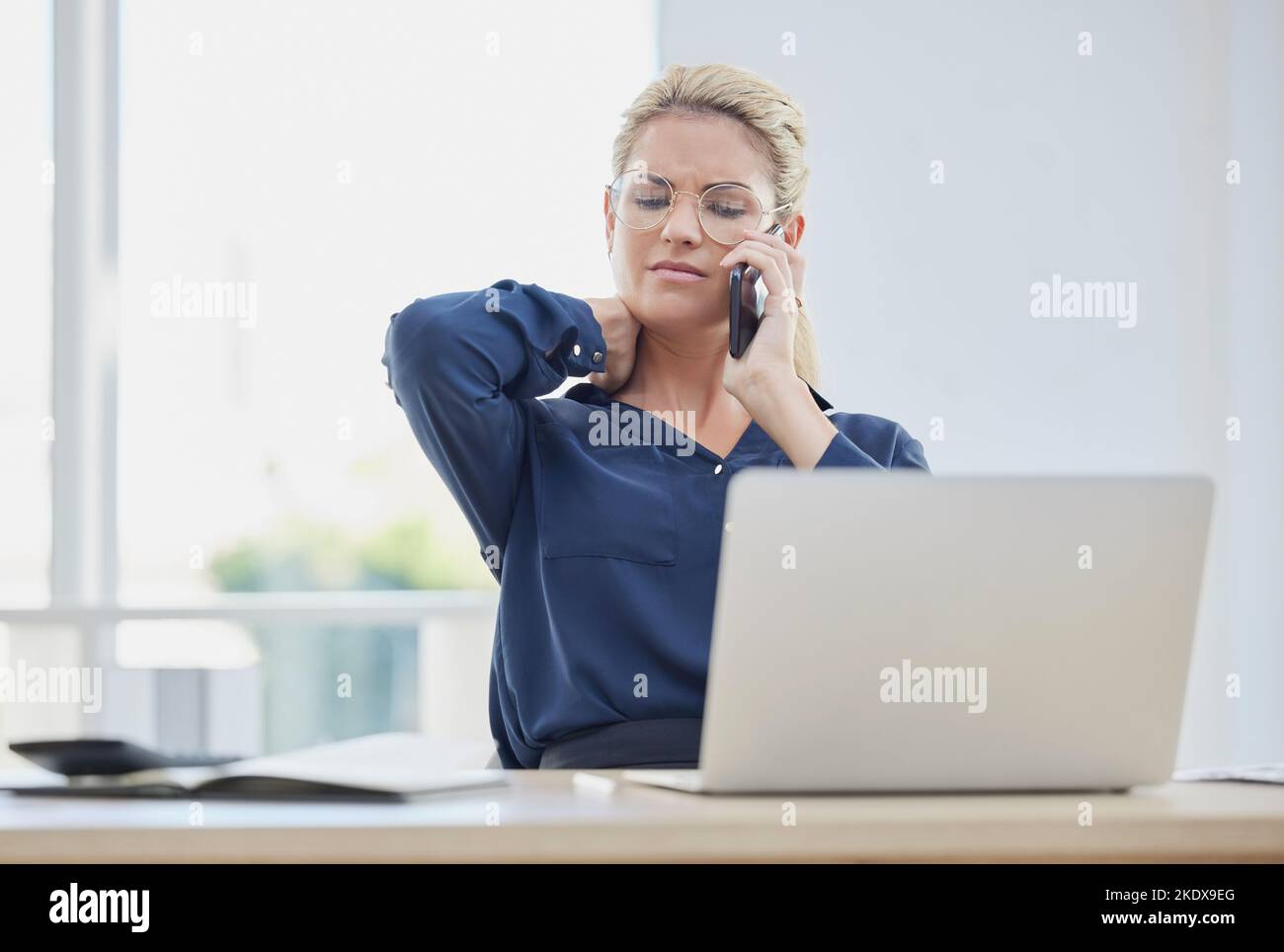 Phone call, stress and neck pain with a business woman at work on a ...