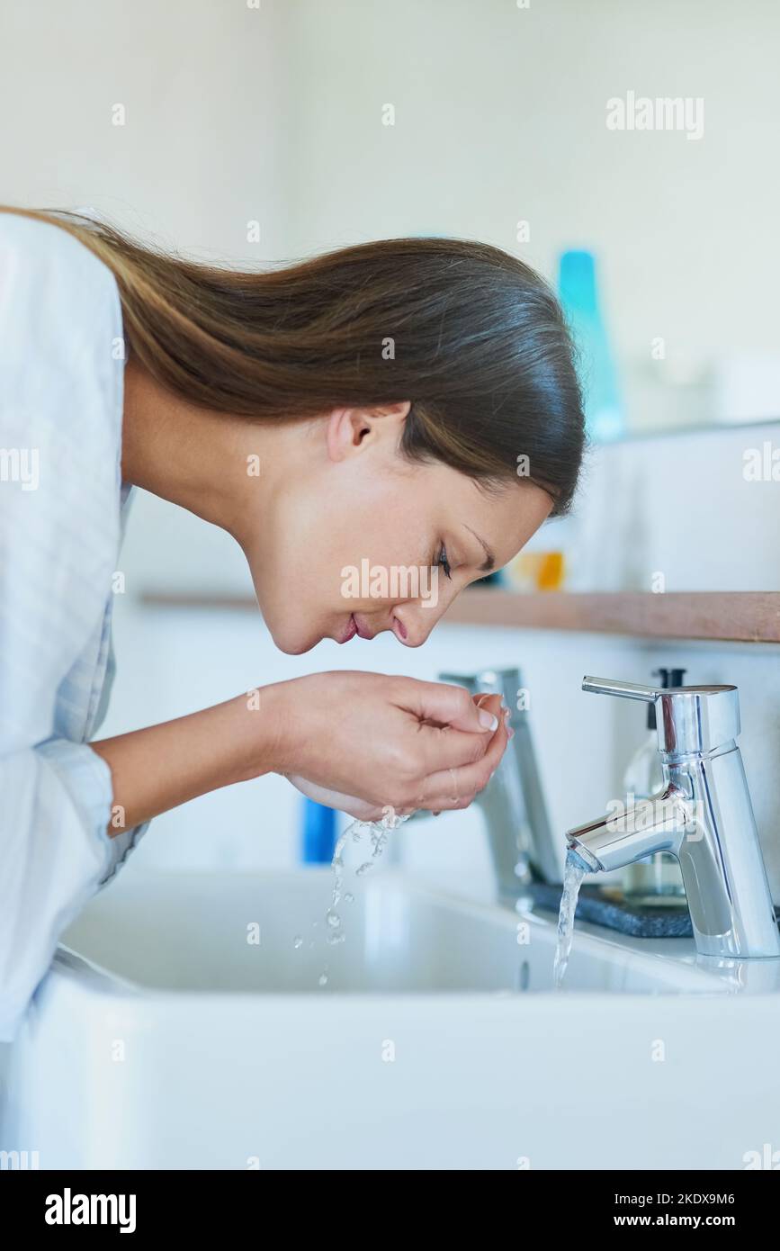 Woman cleaning face over sink hi-res stock photography and images - Alamy