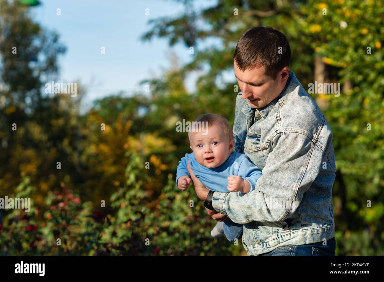 Father holding kid baby son. Adorable child having fun with dad in park ...