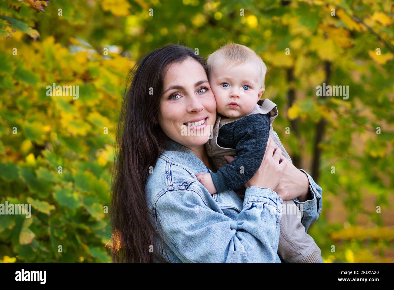 Young mother holding kid baby son. Adorable child boy having fun with ...