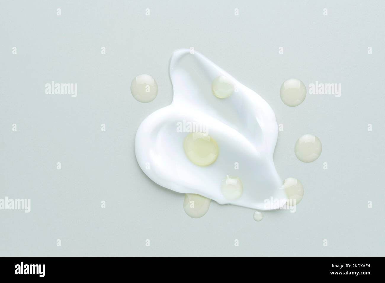 Serum and cream double texture swatch smear on gray background ...