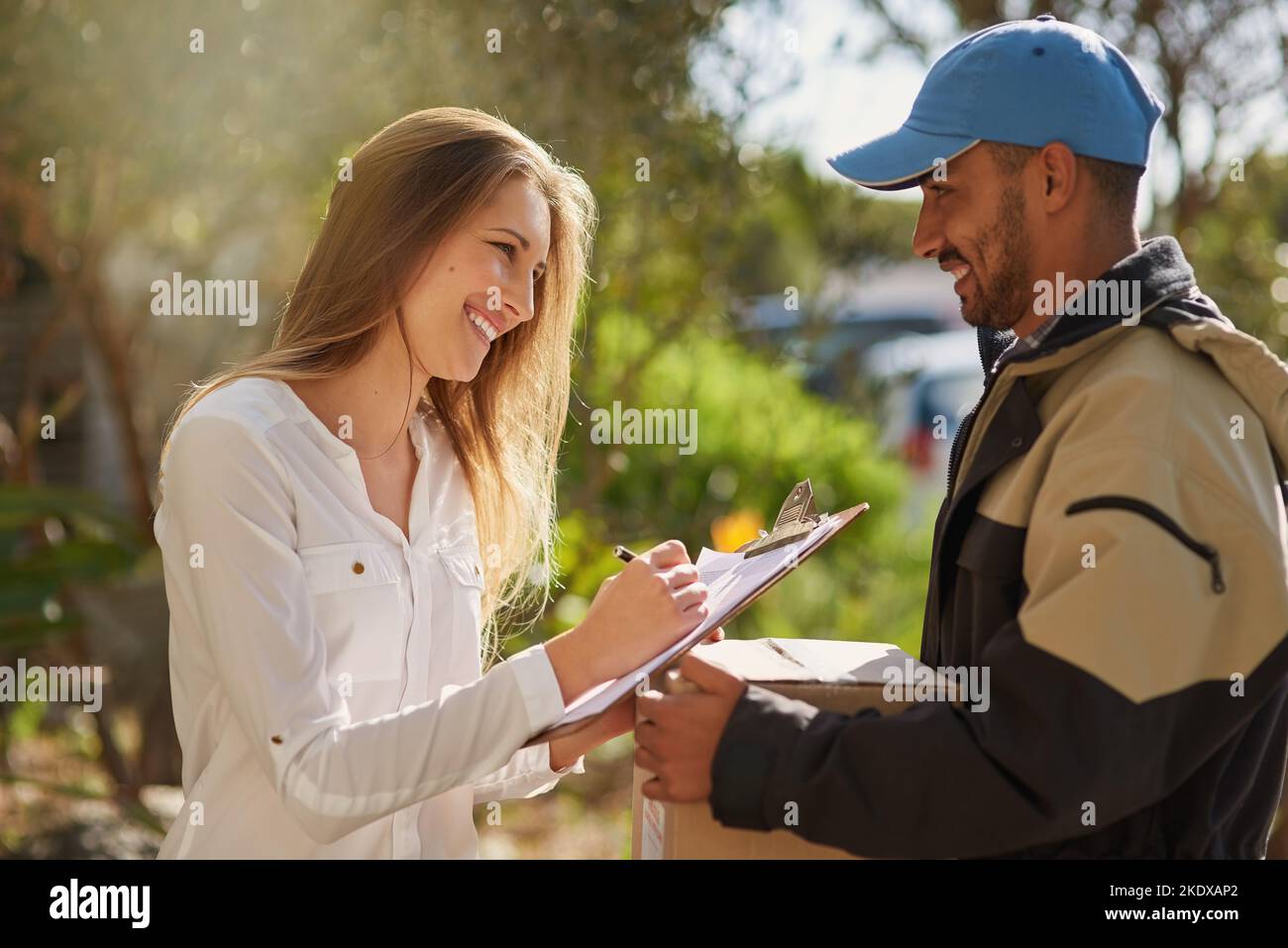 He keeps his customers smiling. a courier delivering a package to a ...