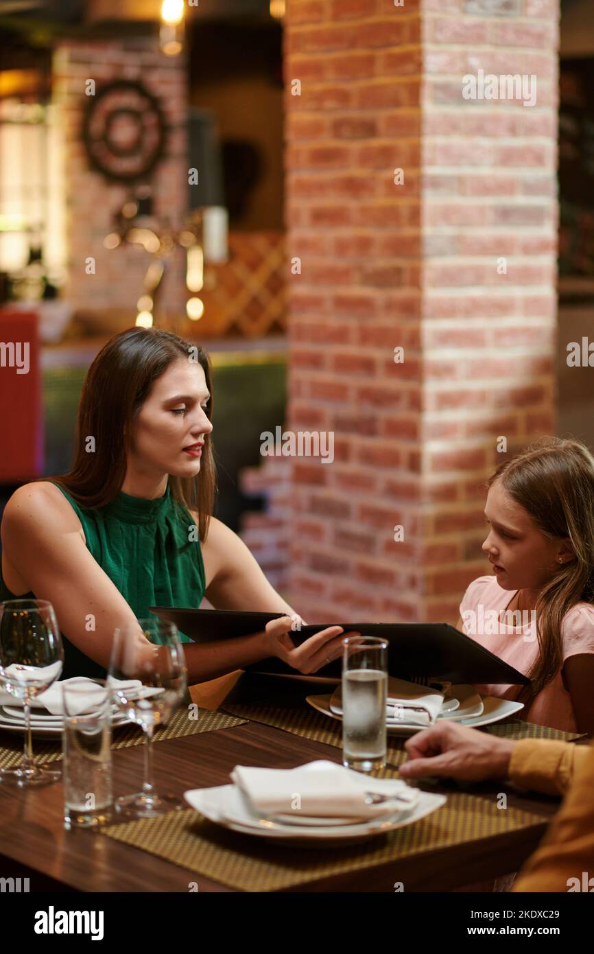 Mother giving manu to daughter and asking to choose what she want to ...