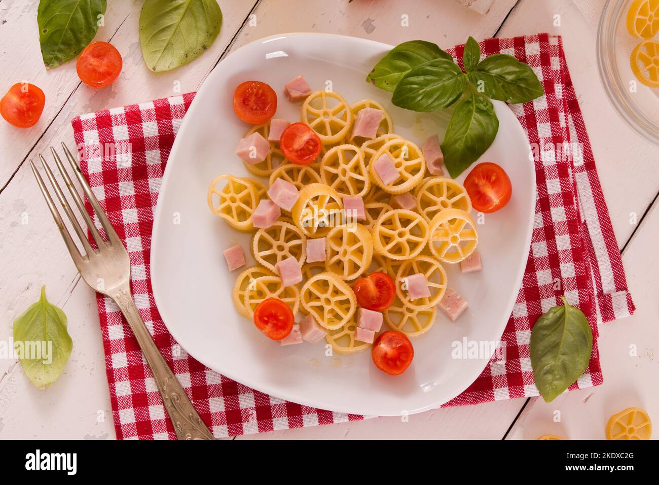 Ruote pasta with tomato and ham Stock Photo - Alamy