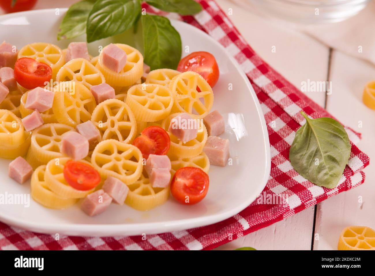 Ruote pasta with tomato and ham Stock Photo - Alamy