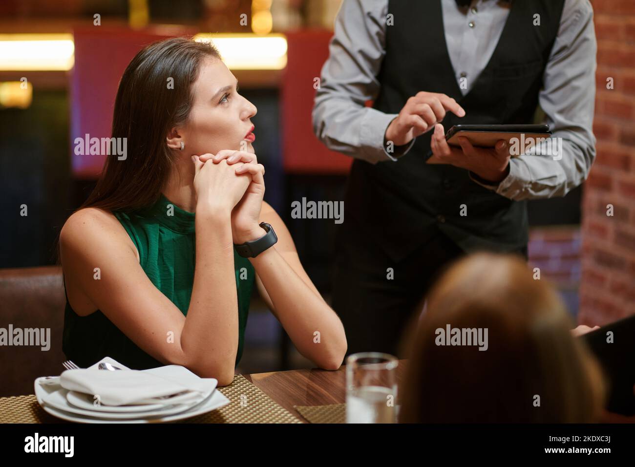 Woman asking restaurant waiter about dish of the day Stock Photo - Alamy