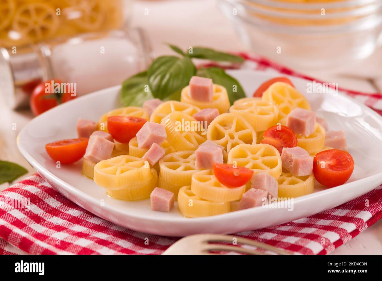 Ruote pasta with tomato and ham Stock Photo - Alamy