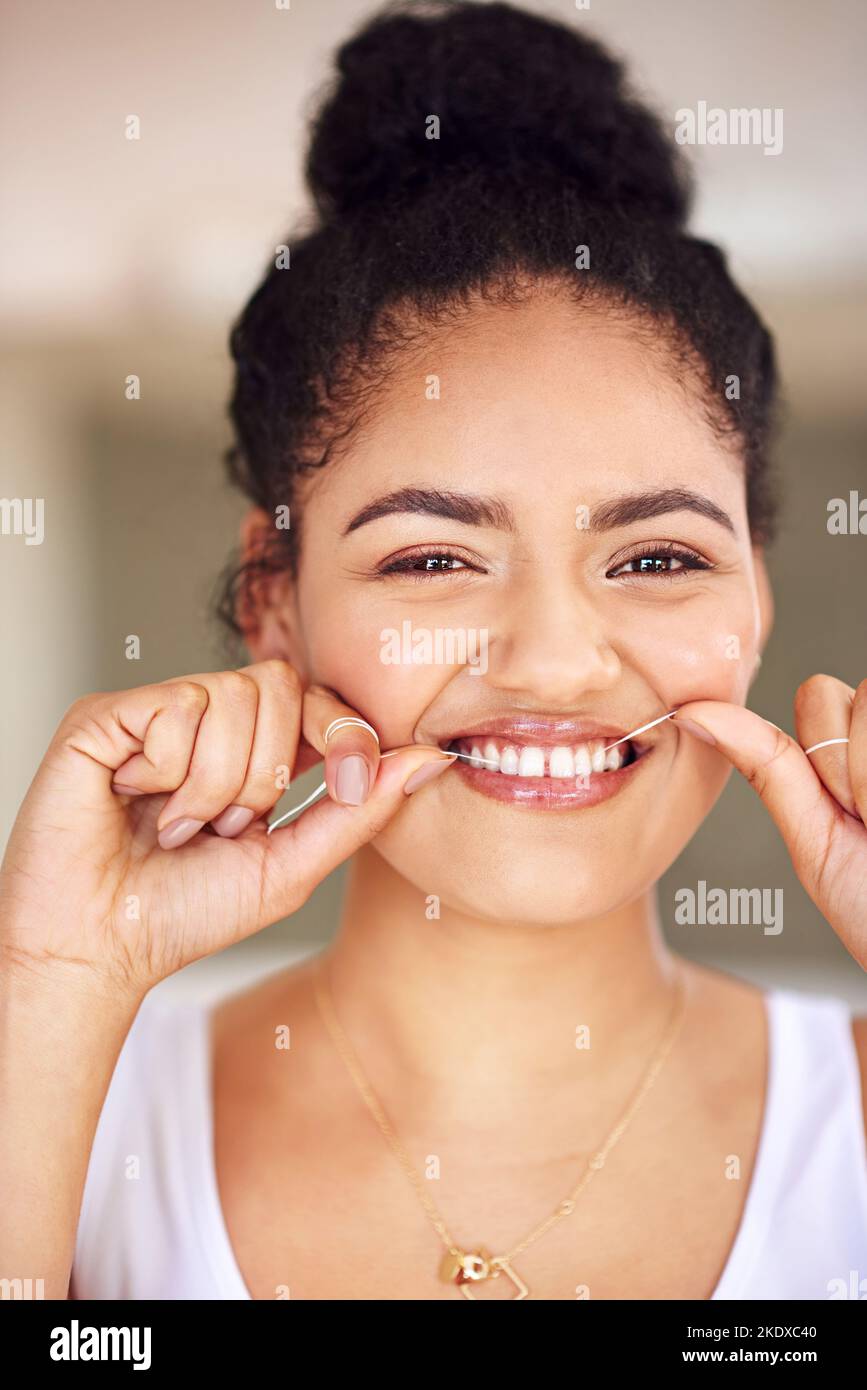 Giving her smile a thorough cleaning. Portrait of a young woman ...