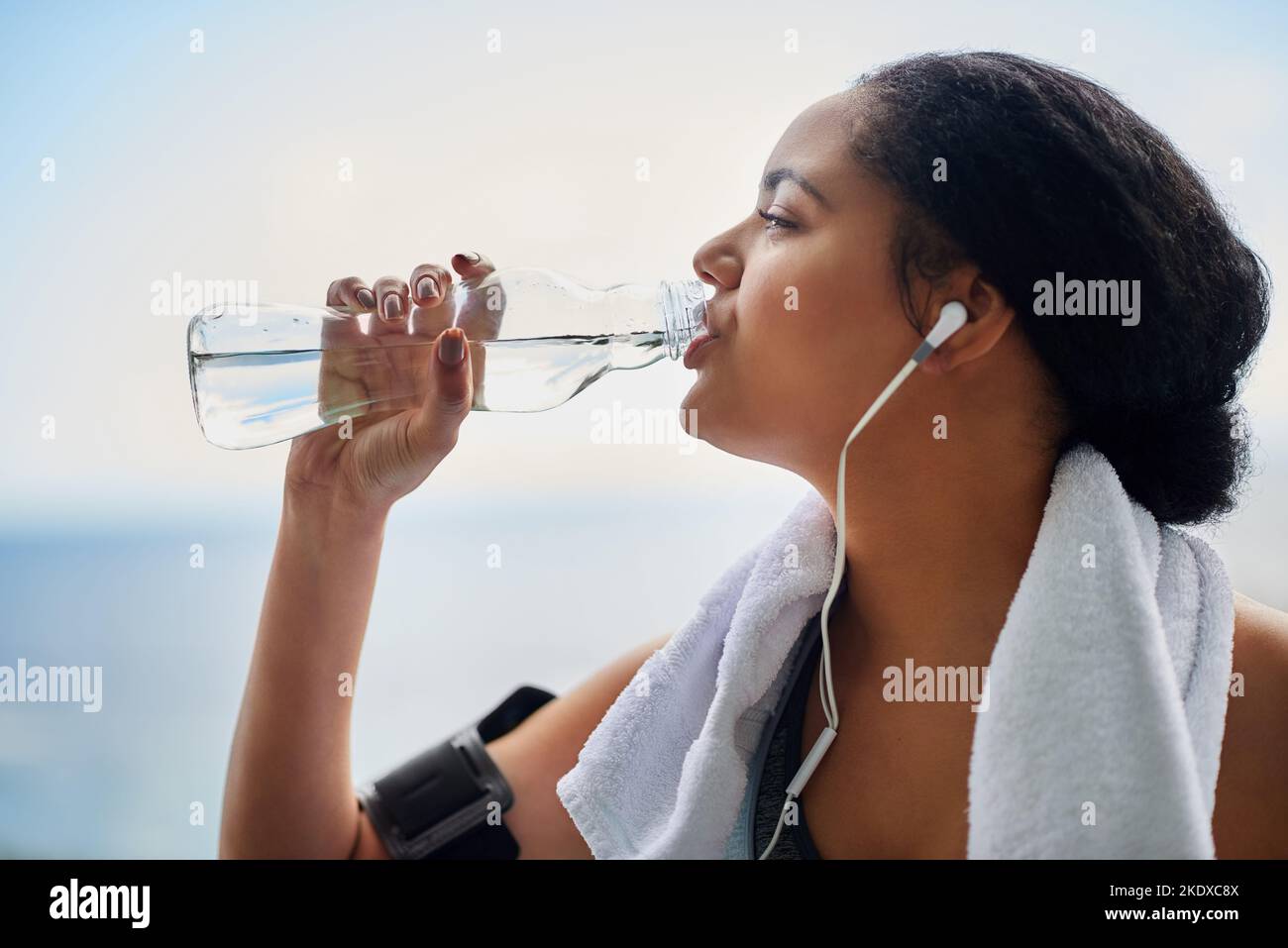 Staying well hydrated throughout her workout. a sporty young woman ...