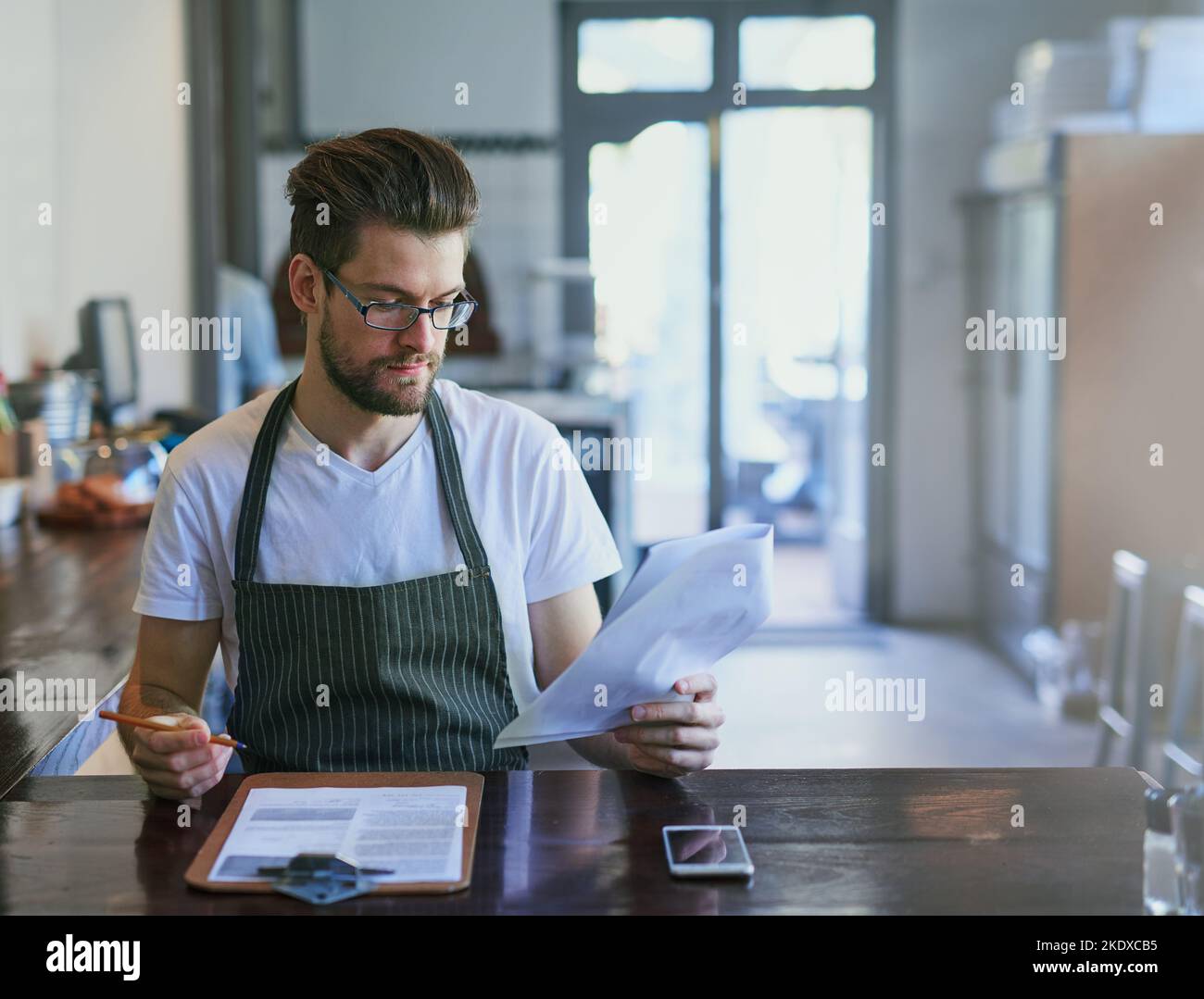 Running his coffee shop like a well-oiled machine. a young barista ...