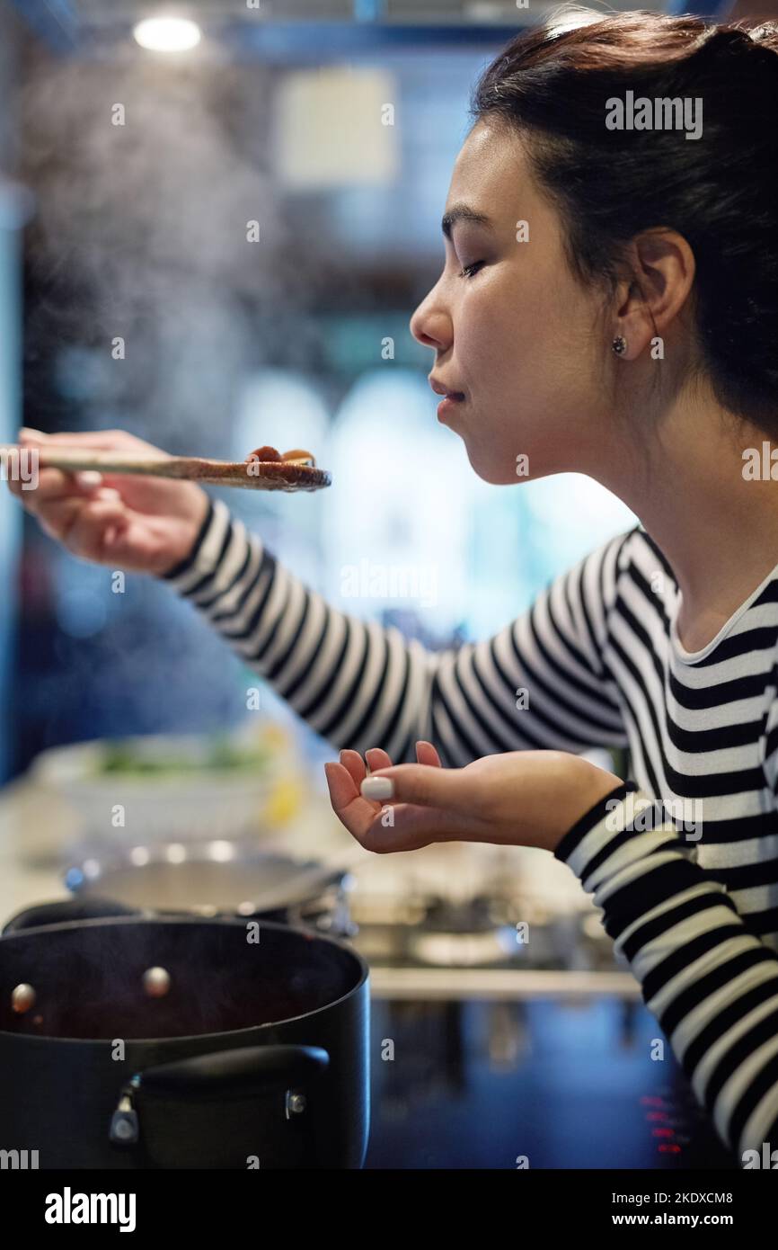 Ensuring shes added the right amount of seasoning. an attractive young ...