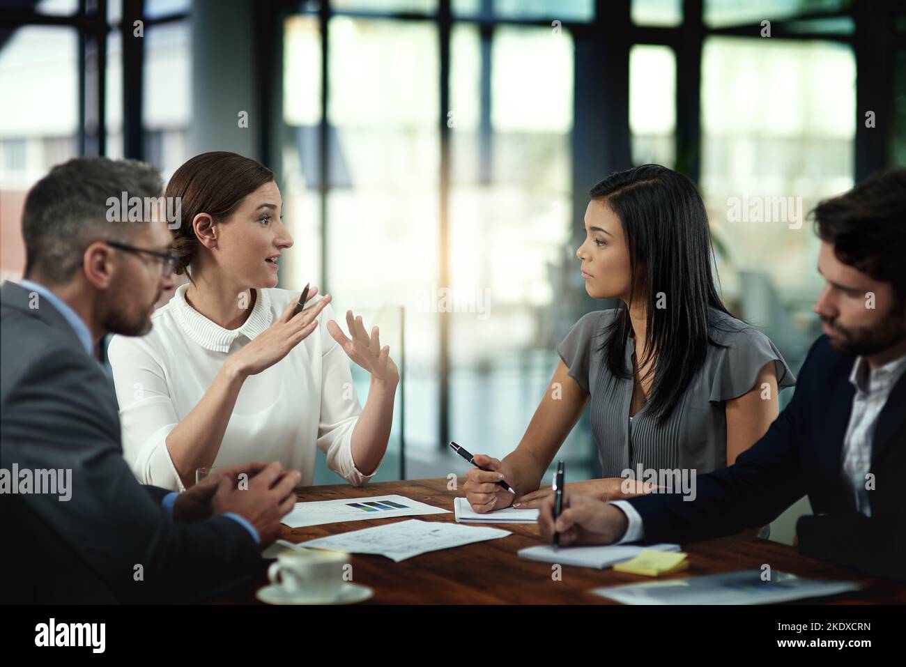 Lets bring these things together. a group of businesspeople meeting in ...
