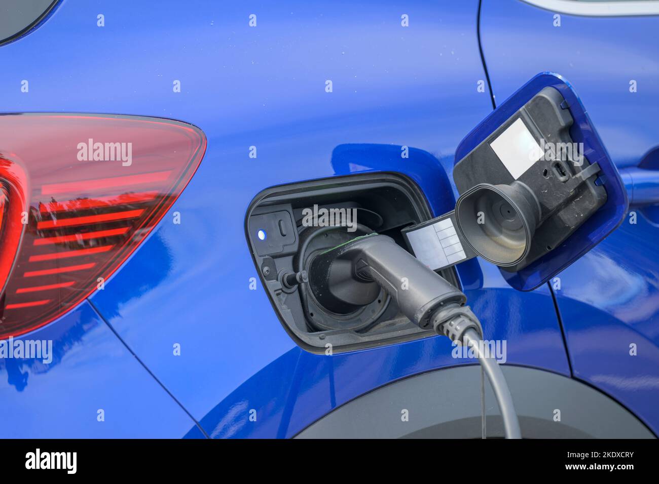 A blue car with charging plug Stock Photo - Alamy