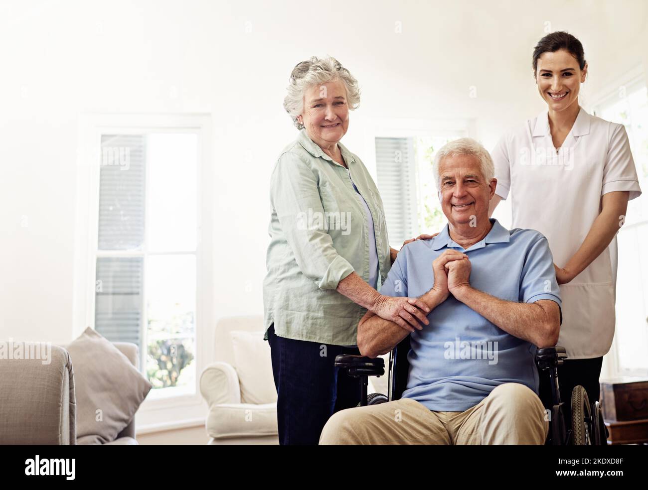 They are both there to care for him. Portrait of a smiling caregiver ...