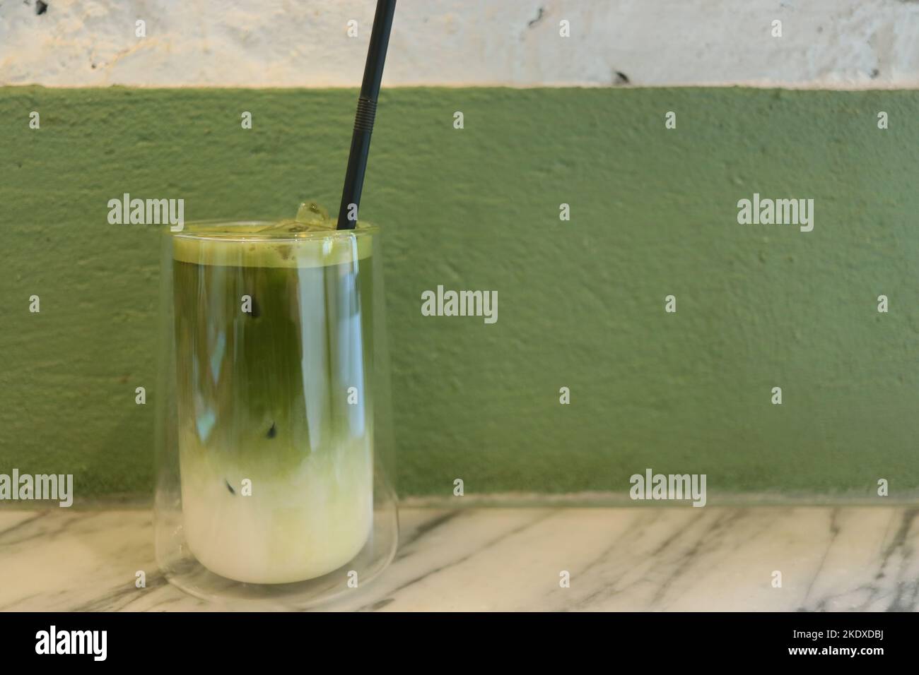 matcha milk tea with green cement background Stock Photo - Alamy