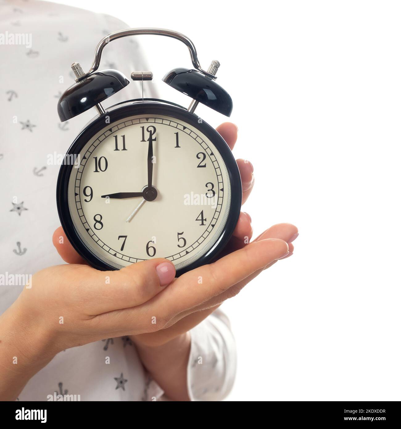 Woman hands holding black alarm clock Stock Photo - Alamy