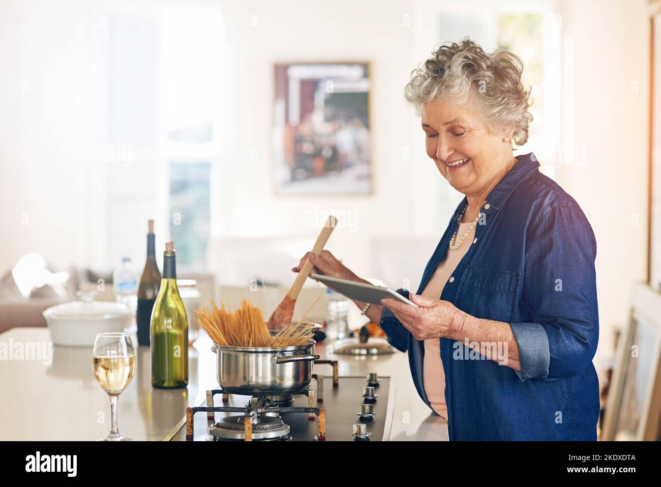 This recipe is so easy to follow. a senior woman using a digital tablet ...