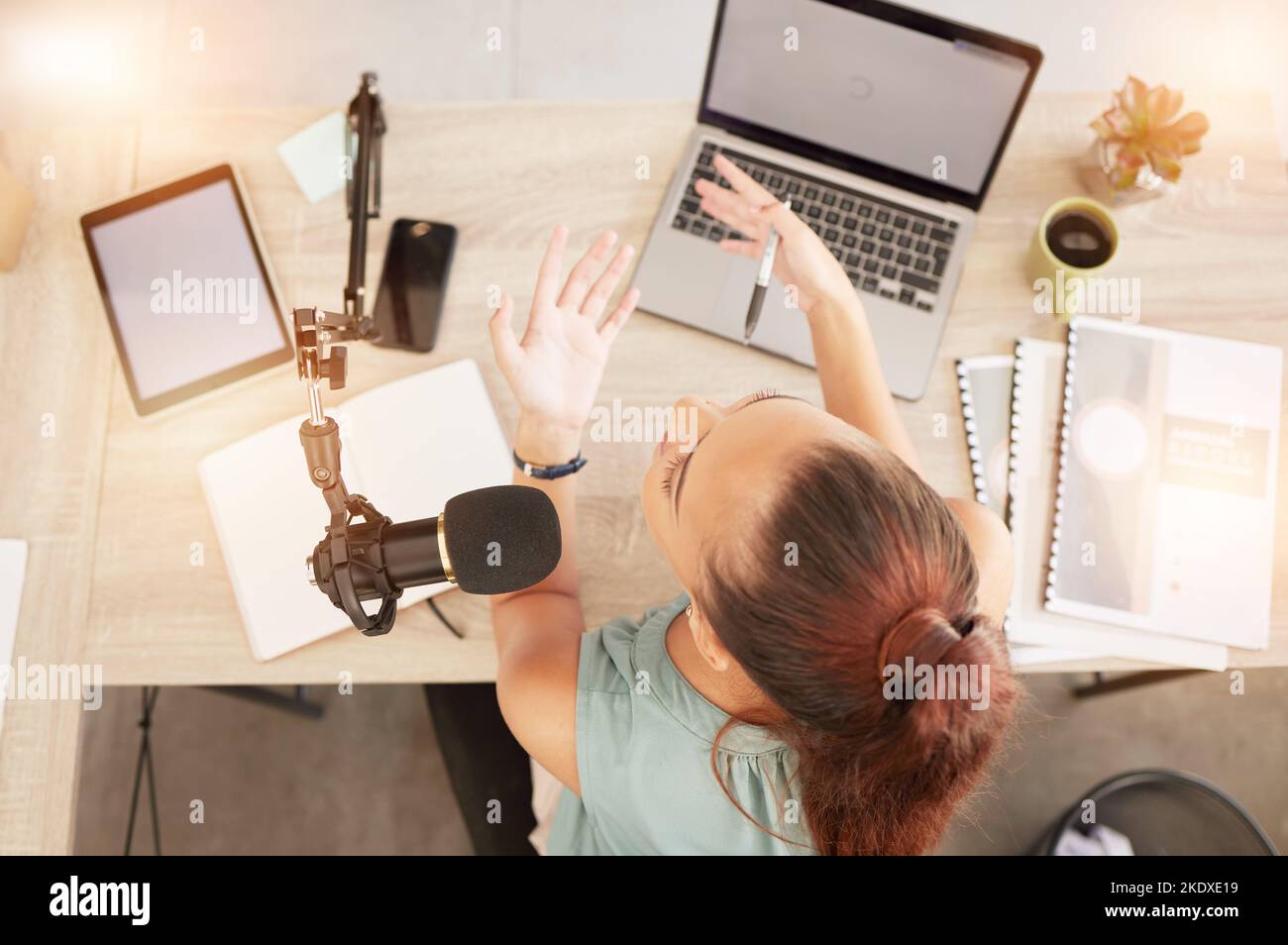 Top view, podcast microphone and woman on laptop recording audio for ...