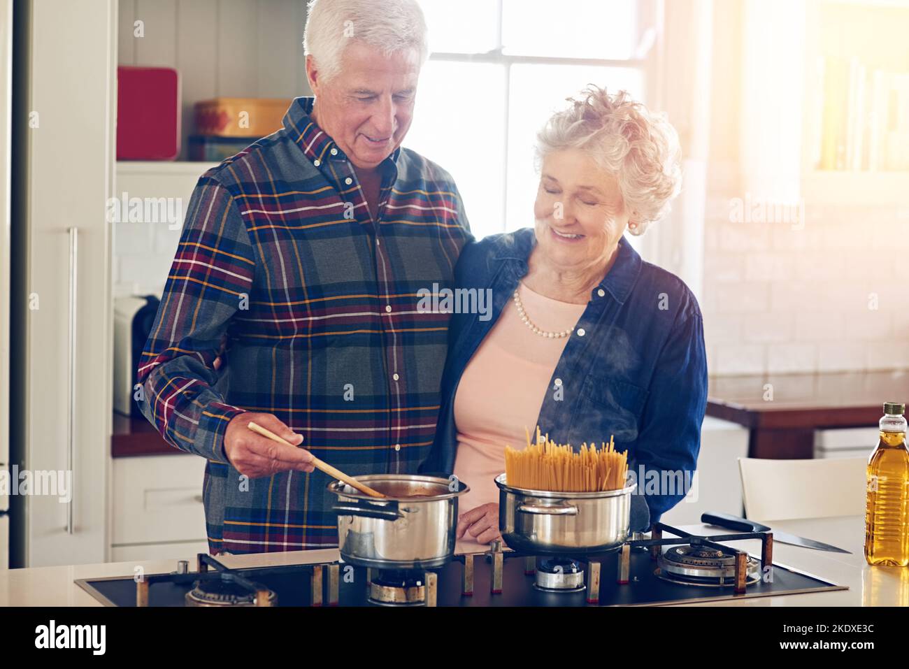 Cooking together in the heart of their home. a senior couple cooking ...