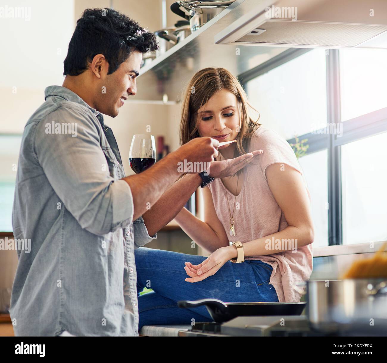 Have a taste...a young man giving his wife a taste of the meal hes ...