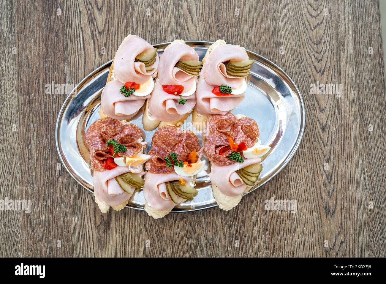 variation of bread with spread of cheese, ham, egg and vegetables Stock ...