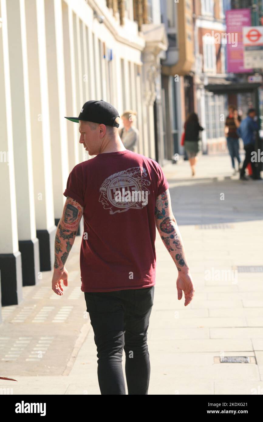 Street style photograph of fashionable man with tattoos in T shirt on ...