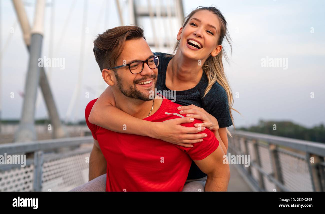 Romantic couple doing sport together on the street. Having fun after ...