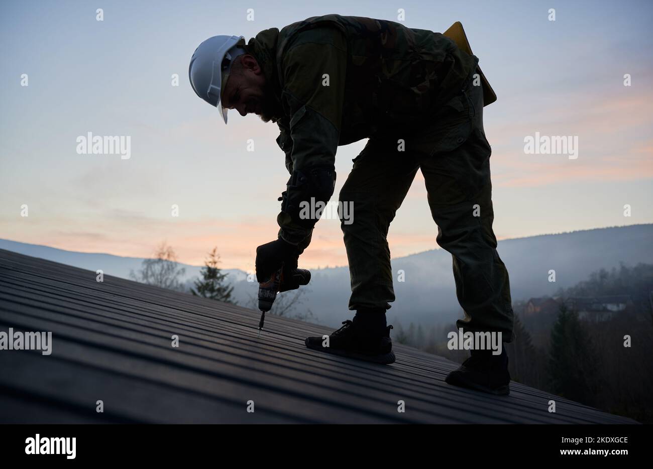 Silhouette Of Worker On Roof
