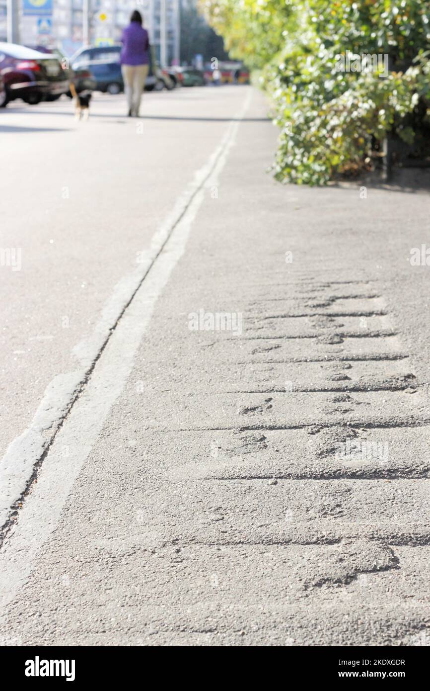 Asphalt is melting from the hot weather and heavy transport left a deep ...