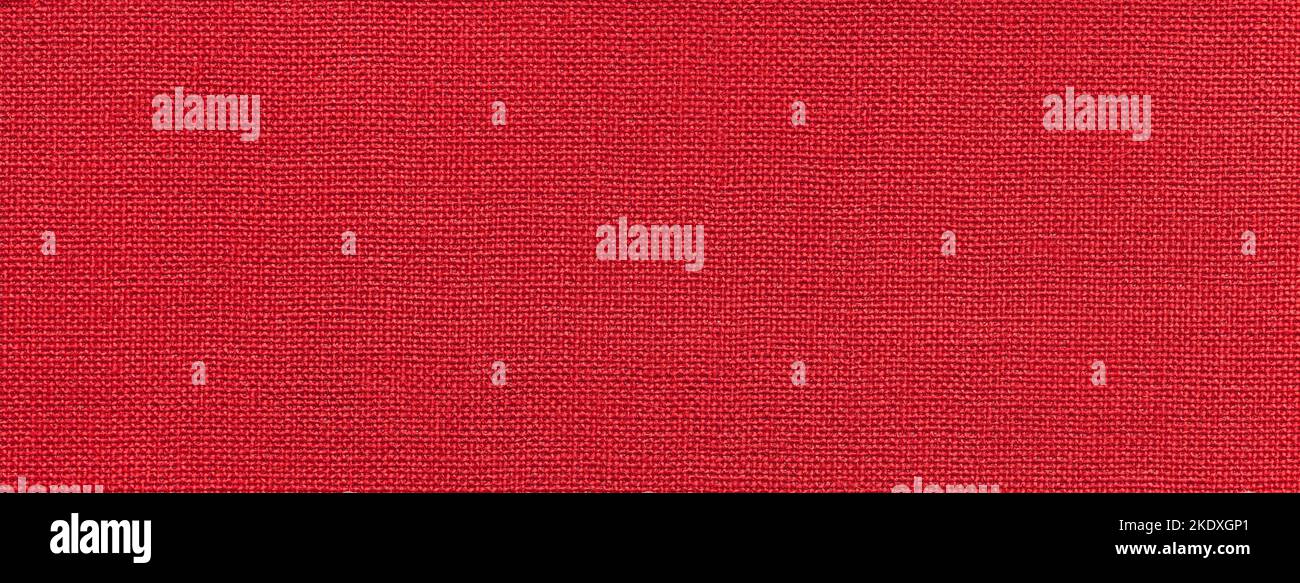 Dark bright red background from a textile material with wicker pattern ...