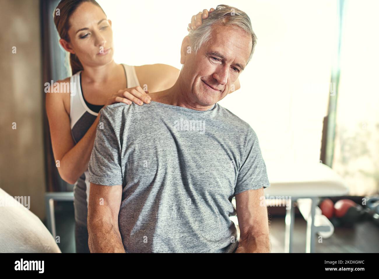 Get rid of sharp neck pain. a senior man being treated by a ...