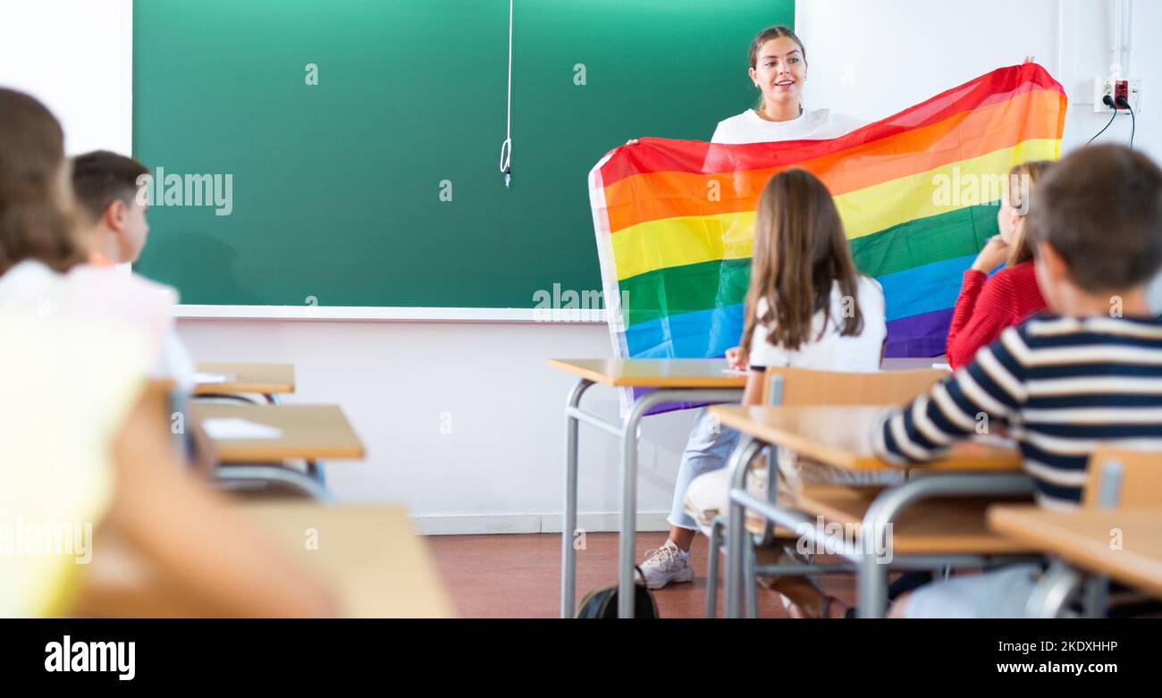 Teacher explaining meaning of LGBT flag to kids in school Stock Photo ...