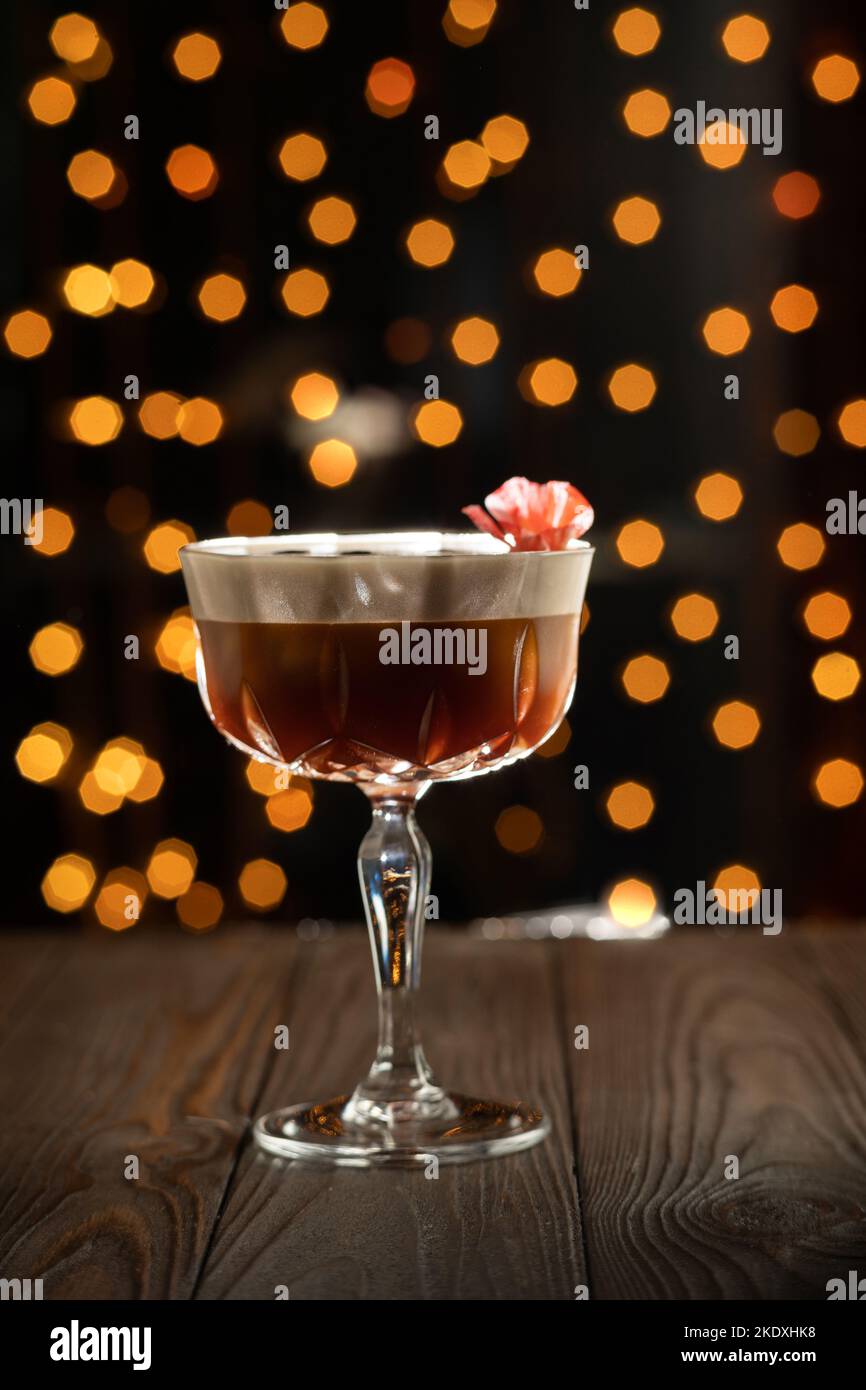 Martini espresso cocktail in glass on wooden table Stock Photo - Alamy