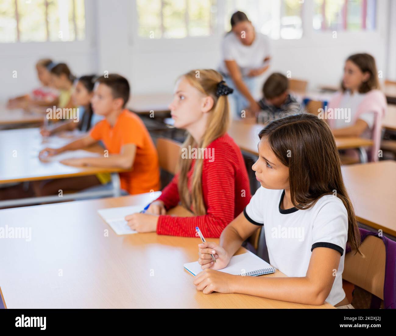 Portrait of school girl who writing exercises at lesson in school Stock ...