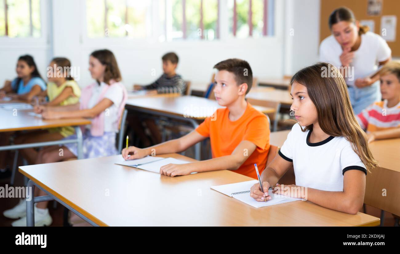 Boy and girl studying in classroom Stock Photo - Alamy