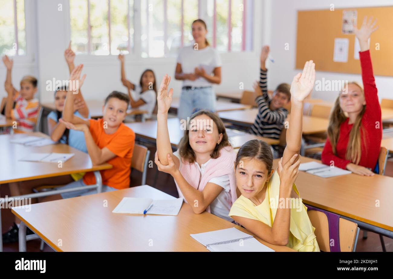 Group of schoolkids hands together during lesson in classroom Stock ...