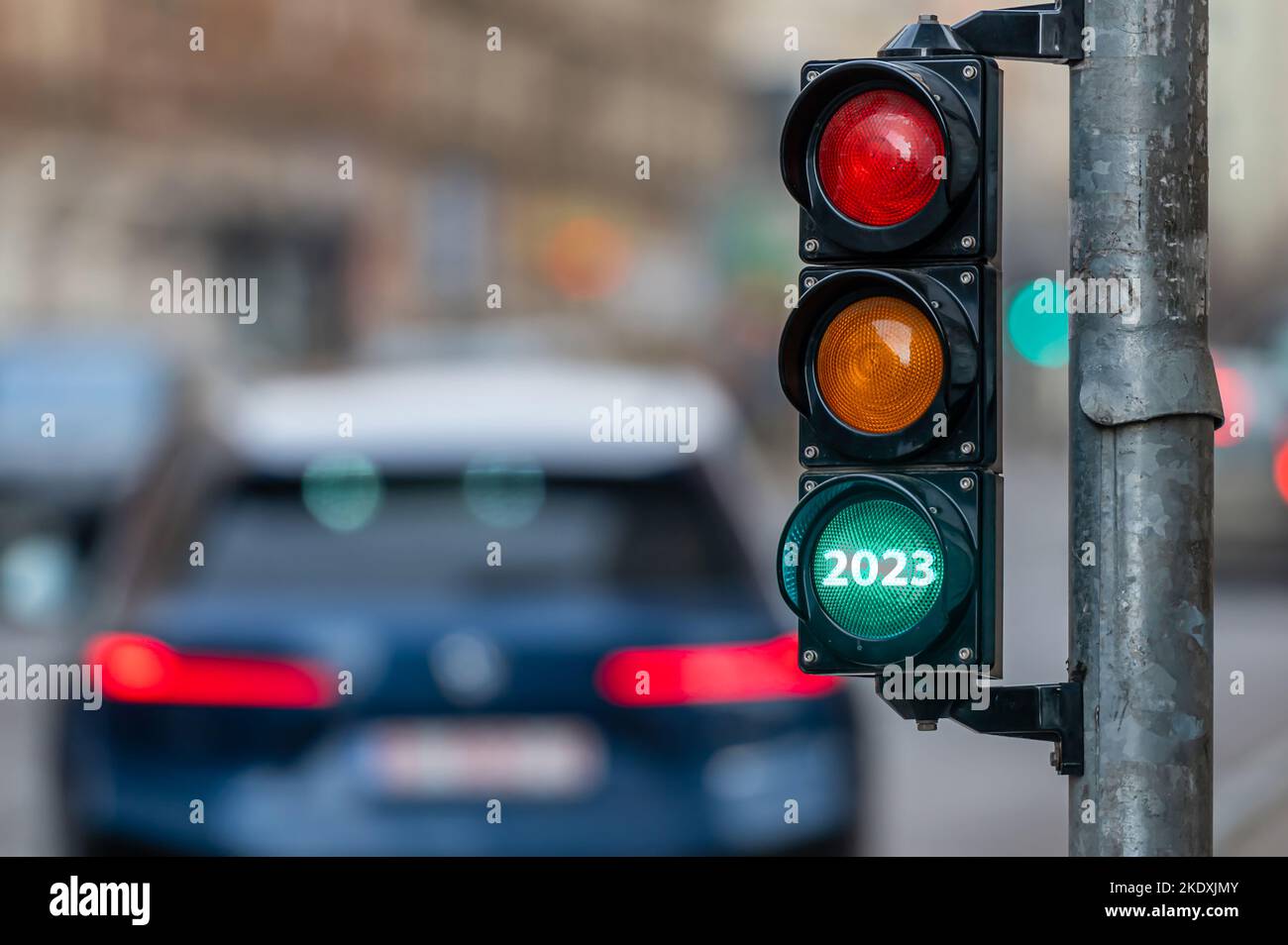 A city crossing with a semaphore. Green light with text 2023 in ...